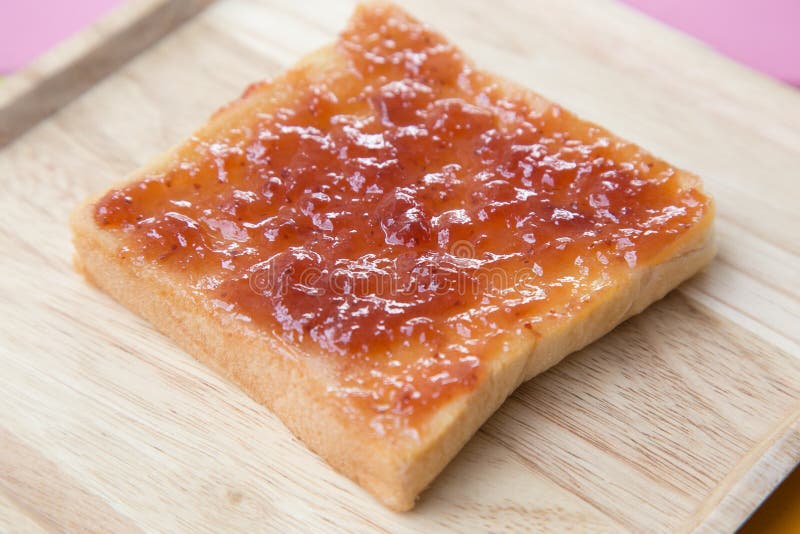 Spread jam on bread stock image. Image of food, hand - 28379647