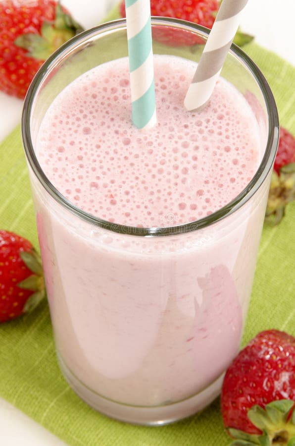 Strawberry Milk Shake in a Glass Stock Photo - Image of straw, green ...