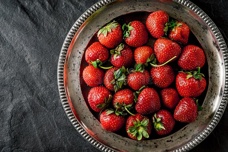 Strawberry in the Old Metal Plate on the Black Stone Table Top View ...