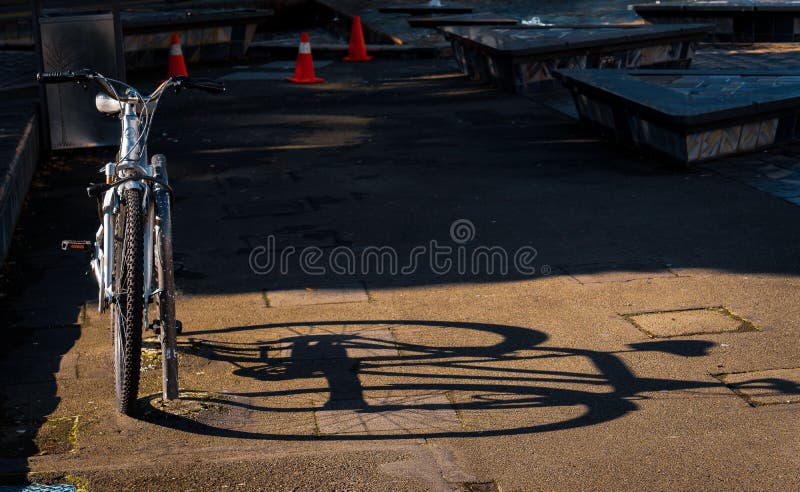 Stray Bike Casting a Shadow on the Sidewalk Editorial Image - Image of ...
