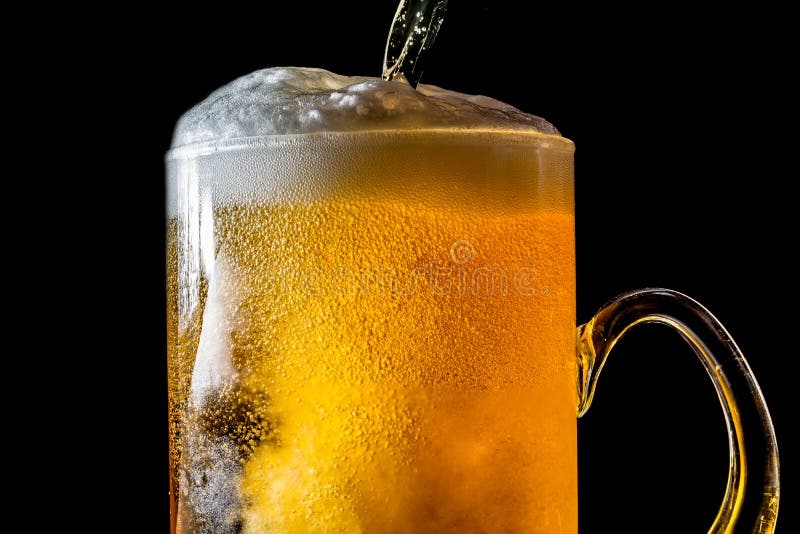 Stream Of Beer Being Pouring Into A Glass With Beer And Foam Isolated