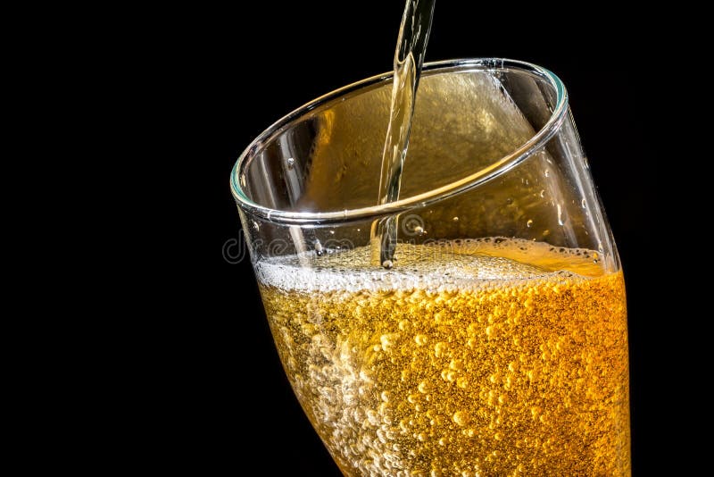Stream Of Beer Being Pouring Into A Glass With Beer And Foam Isolated