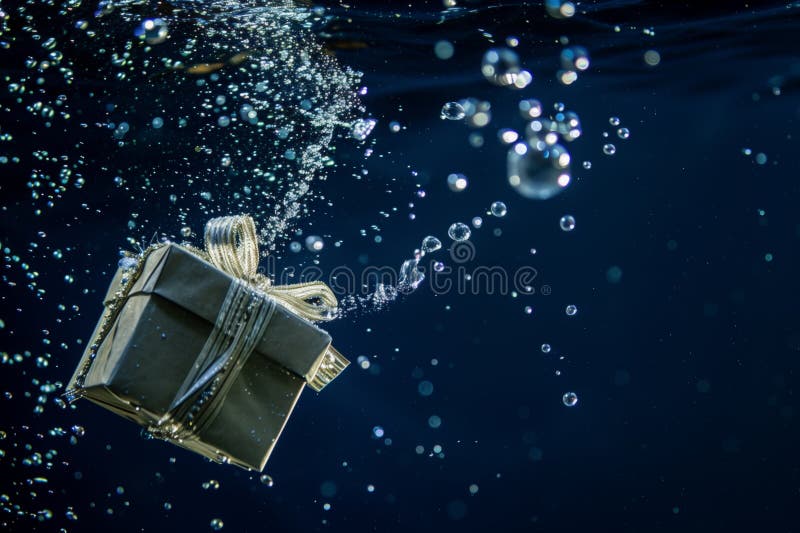 Stream of Bubbles Escaping from a Gift Box Being Submerged Stock Photo ...