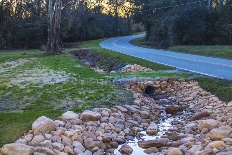 A Stream and Curvy Road in the Evening - Golden Hour Stock Photo ...