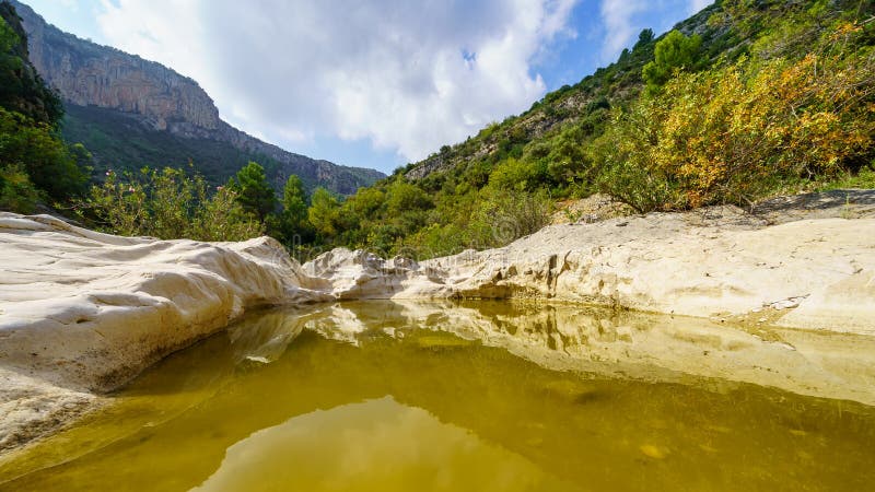 Stream between Eroded Rocks in the Valley between Mountains. Stock ...