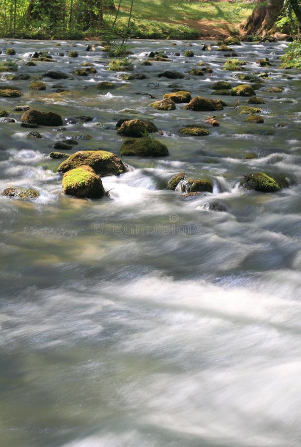 Stream flowing over rocks stock photo. Image of countryside - 30702154