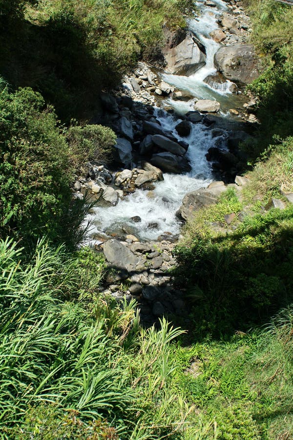 Stream flowing over rocks stock photo. Image of stream - 157532280