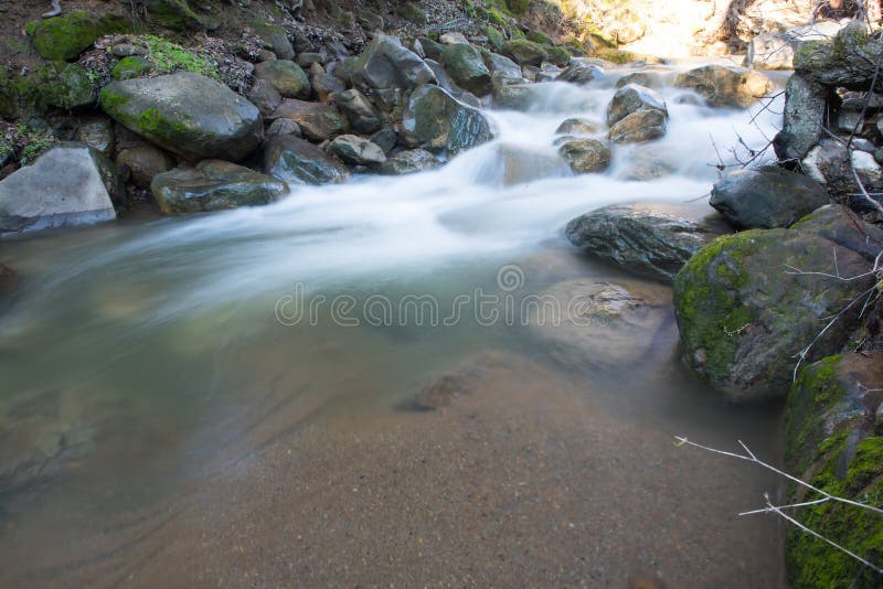 Stream flowing over rocks stock image. Image of creating - 371765571