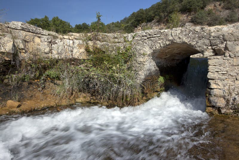 Stream Flowing Under a Small Stone Bridge Stock Image - Image of ...