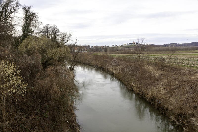 The Stream Flows Next To the Agricultural Land. Stock Photo - Image of ...