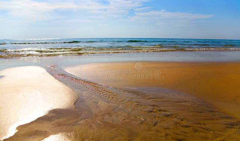The Stream Flows through the Sand into the Ocean. Stock Photo - Image ...