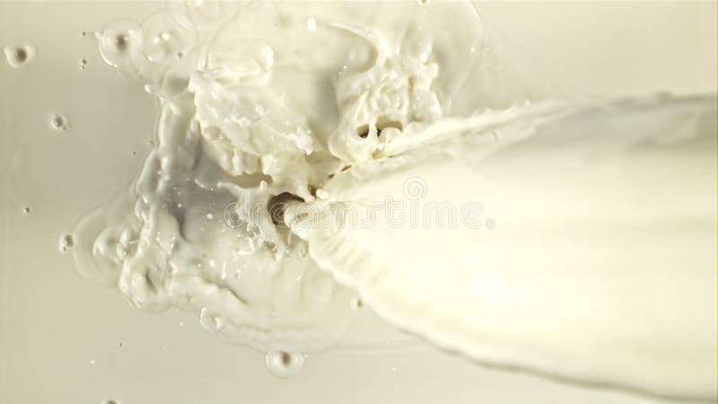 A Stream of Milk Flows with Air Bubbles. Top View. Filmed on a High ...