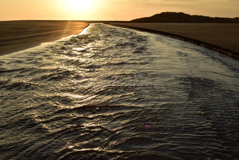 Reflection of the Sun in River Stream on a Beach Stock Photo - Image of ...