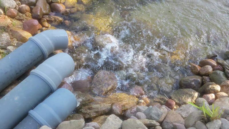 A Stream of Sewage Flows Out of a Plastic Sewer Pipe into the River ...