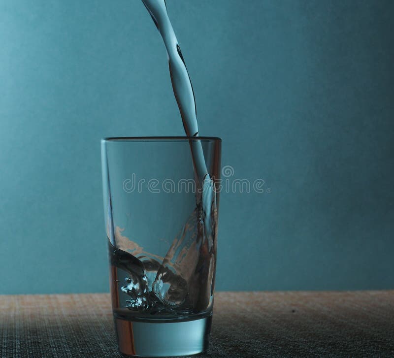 The Stream of Vodka is Poured into a Glass Stock Photo - Image of drip ...