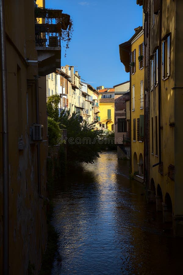 Stream of Water Bordered by Tall Buildings with Trees in a European ...