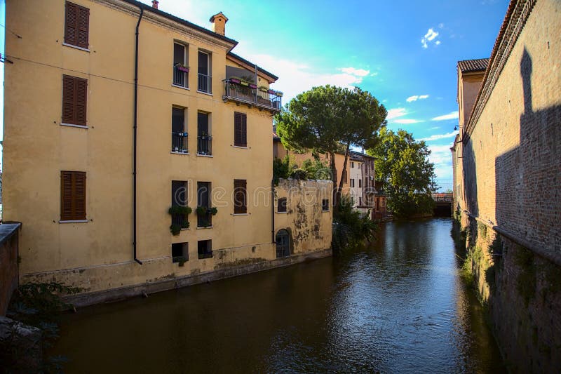 Stream of Water Bordered by Tall Buildings with Trees in a European ...