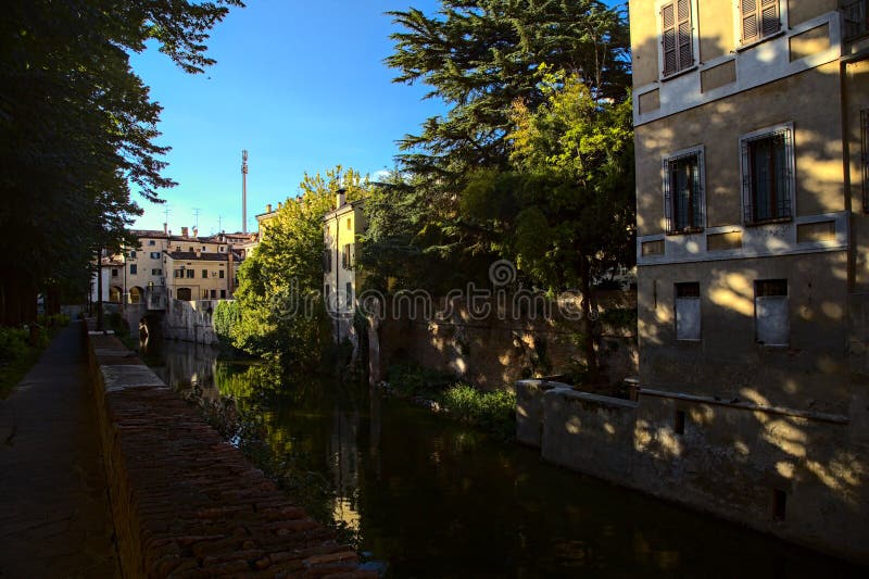 Stream of Water Bordered by Tall Buildings with Trees in a European ...