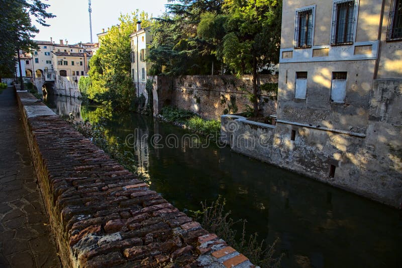 Stream of Water Bordered by Tall Buildings with Trees in a European ...