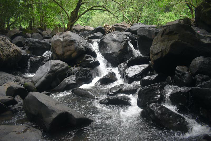 A Stream of Water Falling between the Rocks of a River Stock Image ...