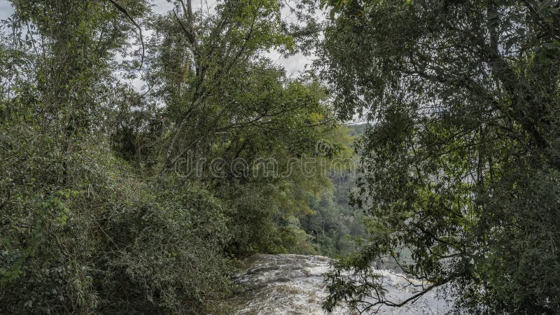 A Stream of Water Falls from the Edge of the Ledge into the Abyss ...