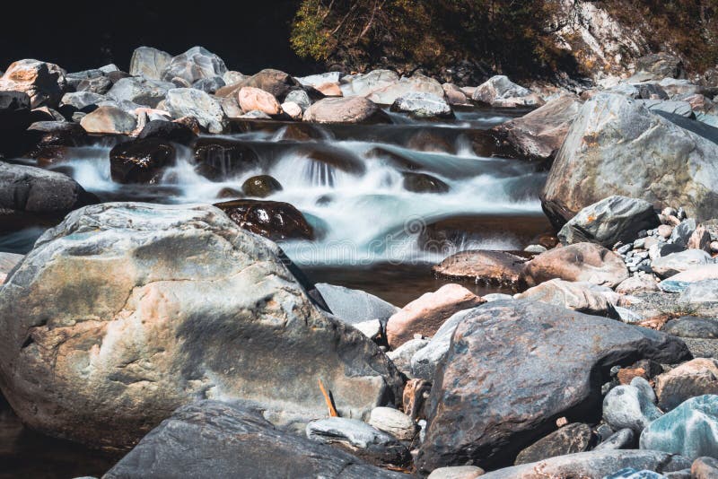 Stream of Water Flowing through Large Rocks Stock Photo - Image of ...