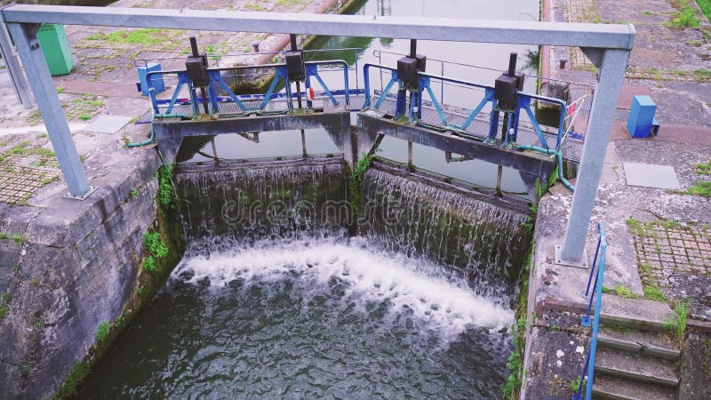 A Stream of Water Flows through the Closed Iron Gates of the Water ...