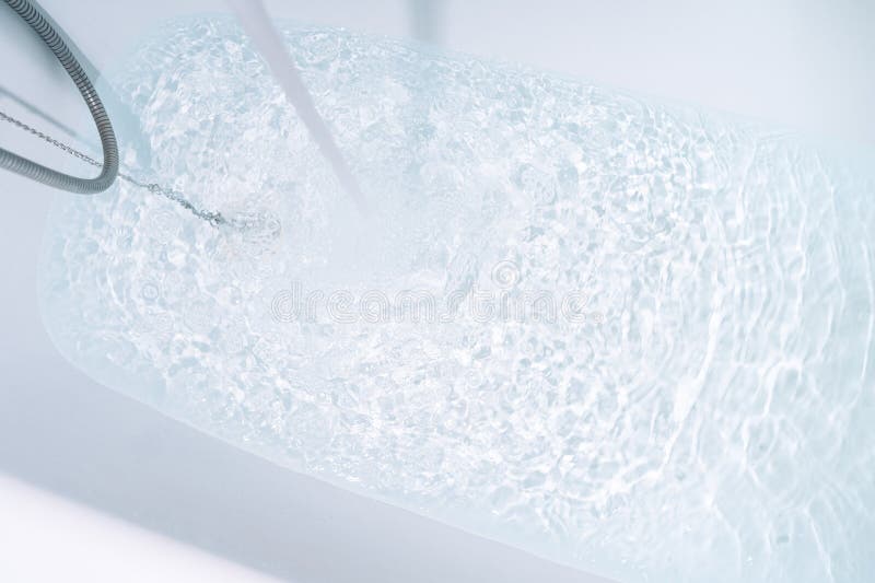 A Stream of Water Flows from a Faucet into a Bathtub Stock Image ...