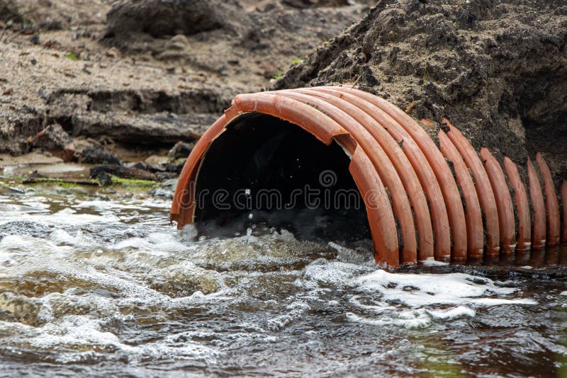 A Stream of Water Flows from a Large Flexible Pipe - Hose Stock Photo ...