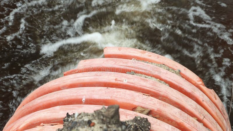 A Stream of Water Flows from a Large Flexible Pipe Stock Video - Video ...