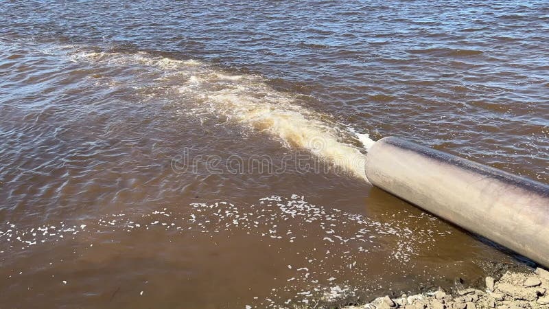 Stream of Water Flows into the River from an Iron Pipe. Stock Footage ...