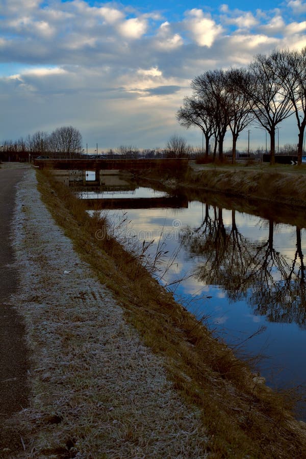 Stream of Water Next To a Path in Winter with the Sky Casted in the ...