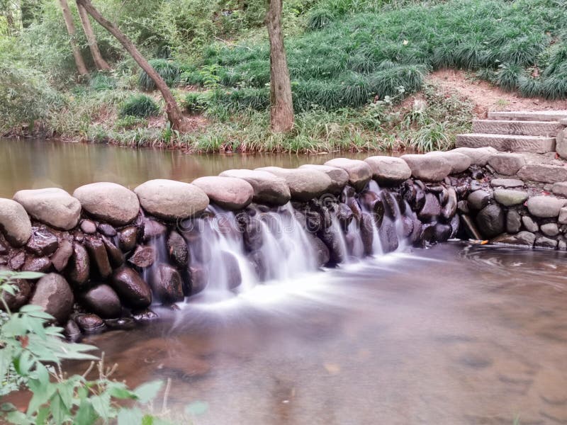 Stream water in the park stock photo. Image of waterfall - 260434276