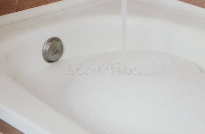 Stream of Water Pouring into the Bath with Foam. Stock Photo - Image of ...