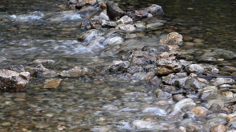 A Stream of Water is Flowing Down a Rocky Hillside Stock Video - Video ...