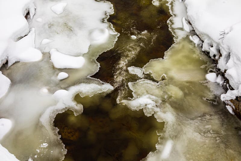 A Streaming Winter River between Ice and Snow, in the Mountains of ...