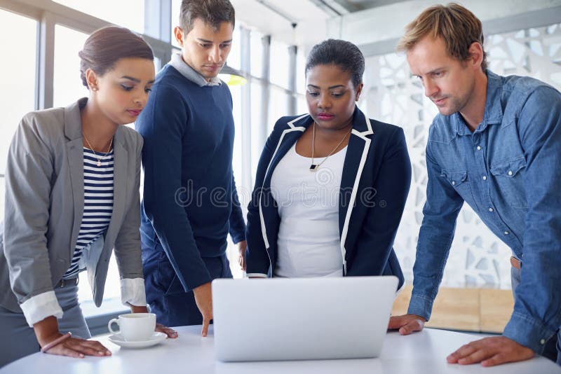 Streamlining Their Workflow. a Group of Coworkers Working Together on a ...