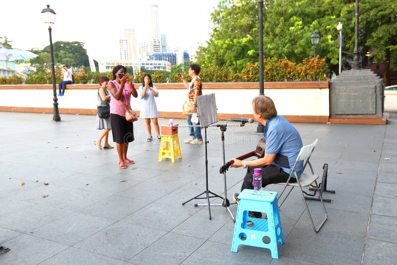 Street busker in Singapore editorial stock photo. Image of entertain ...