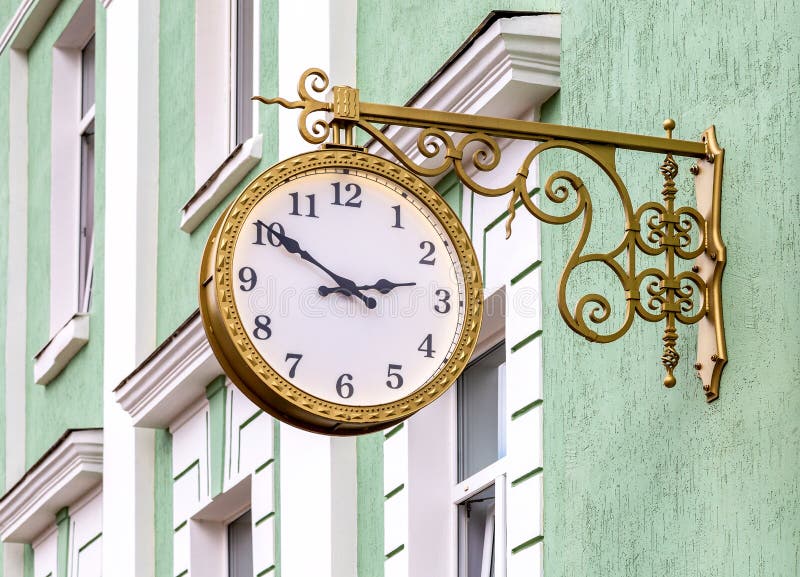 Street Clock Hanging on a Wall of Brick Building Stock Photo - Image of ...