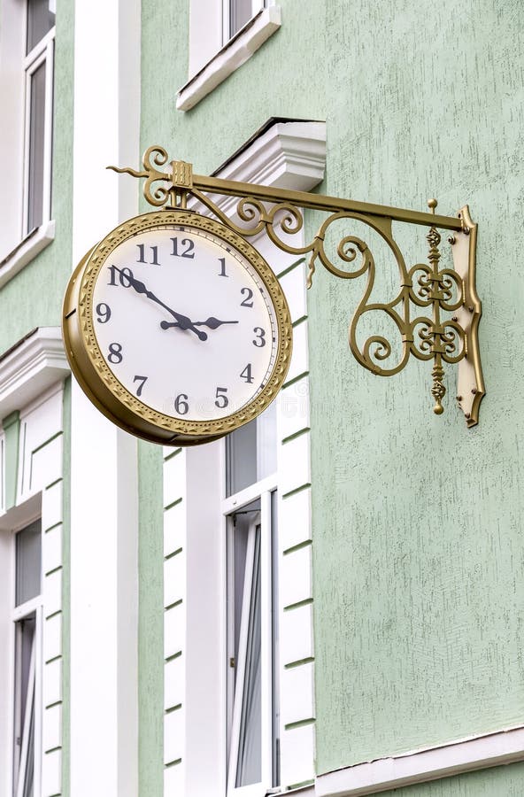 Street Clock Hanging on a Wall of Brick Building Stock Image - Image of ...