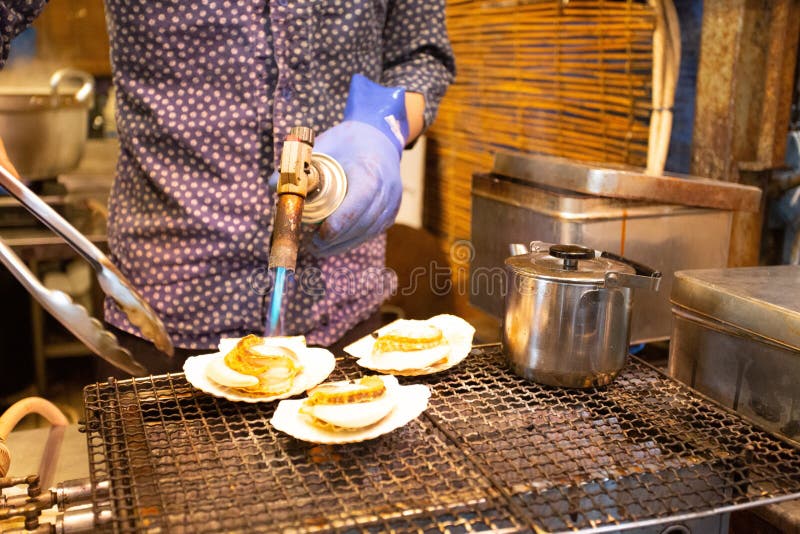 Street Food Vendor Using a Food Torch in Preparing Food Stock Photo ...
