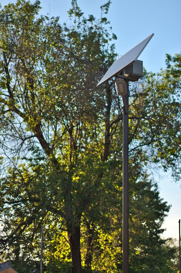 Street Lamp with a Solar Battery Against a Blue Sky and Trees Stock ...