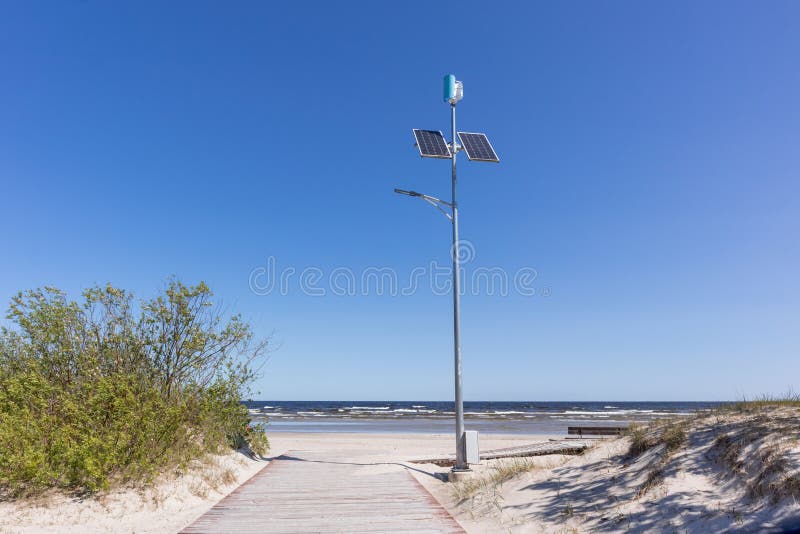 .street Lamp with Solar Panels on a Beach Path Overlooking the Sea ...