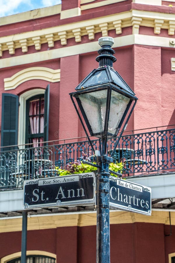 Street Lamp with St. Ann and Chartres Signs in Background of Building ...