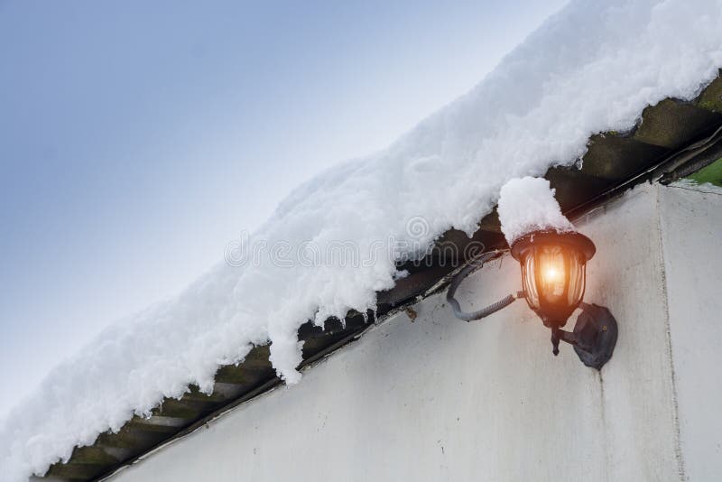Street Lamp Under the Snow on the Wall of the House Stock Image - Image ...
