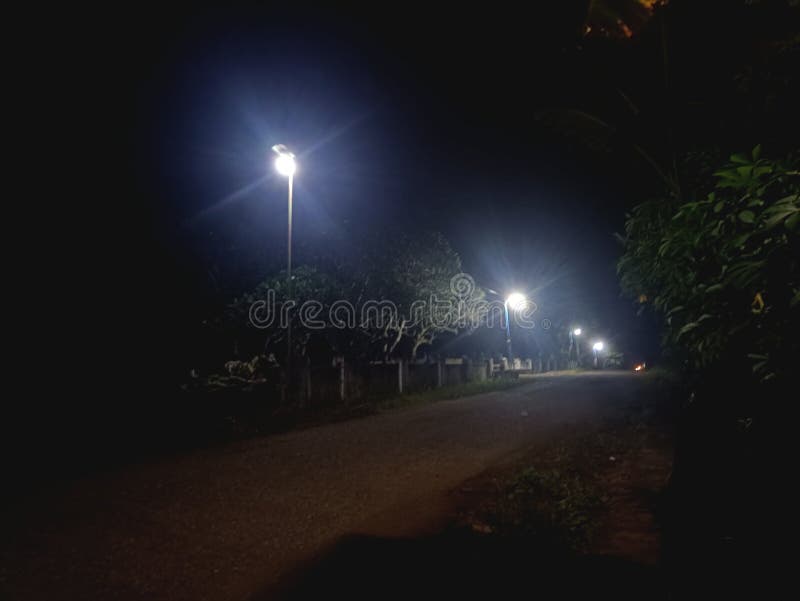 Street Lights Illuminate the Road in Dark Night Conditions Stock Image ... Street Lights Illuminate the Road in Dark Night Conditions Stock Image ...