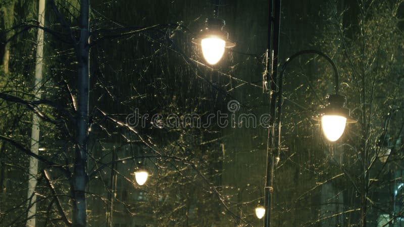 A Rainy Night Scene of a City Street with Wet Pavement and Streetlights ...