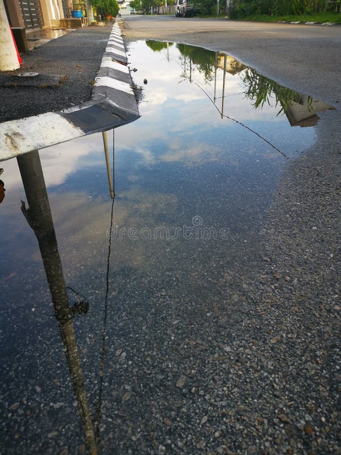 Street Scene Around the Puddle of Water on the Asphalt Stock Photo ...
