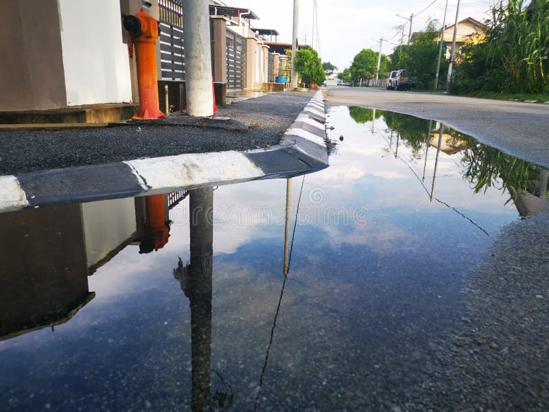 Street Scene Around the Puddle of Water. Stock Photo - Image of dirty ...
