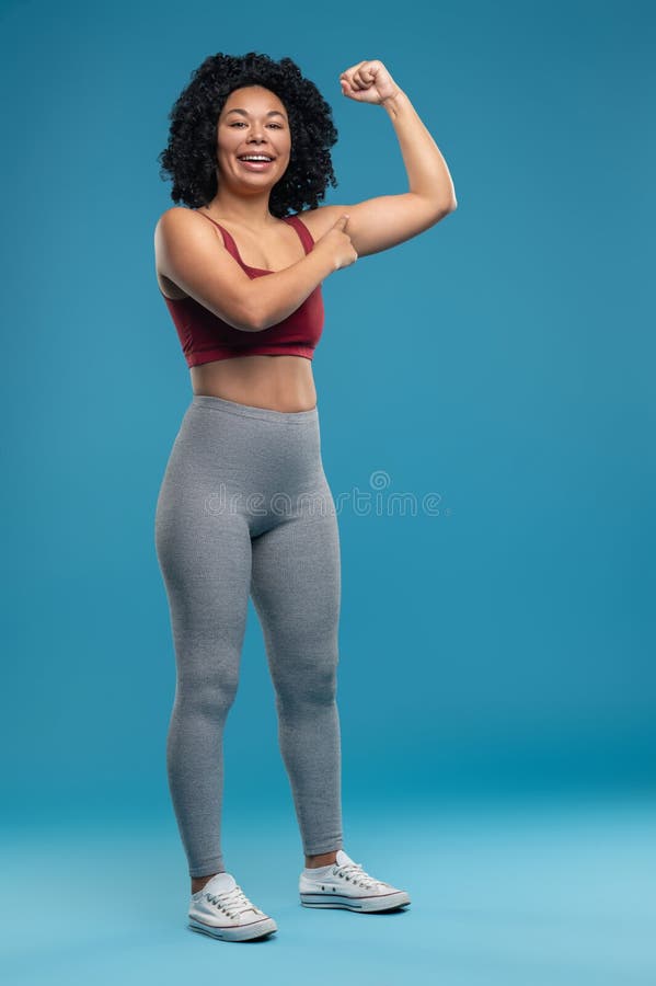 Cute Smiling Woman Showing Her Muscles Stock Image - Image of ...